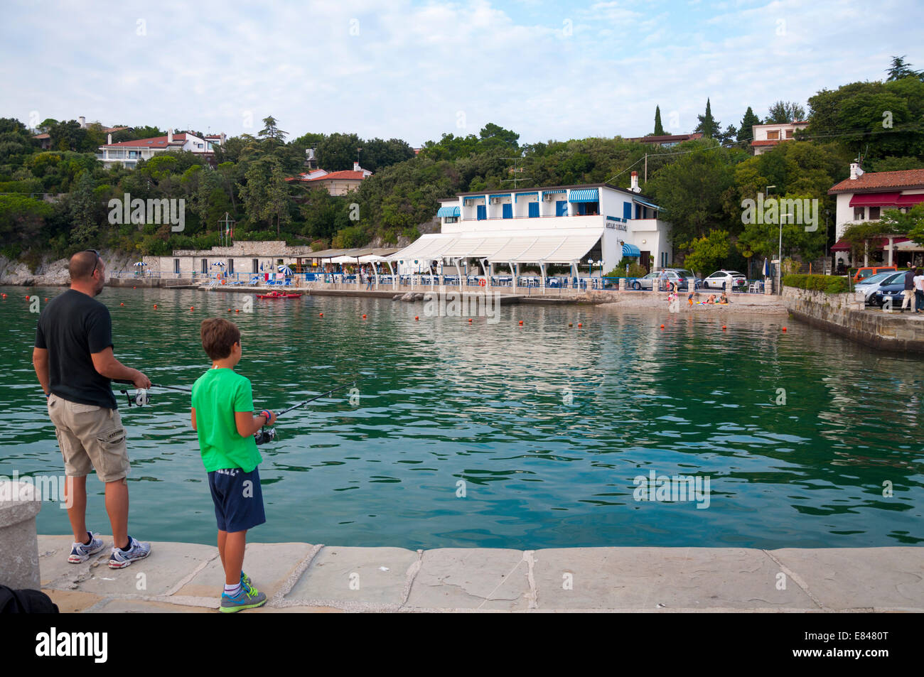 Father and son fishing in Duino harbour Trieste Italy Stock Photo - Alamy