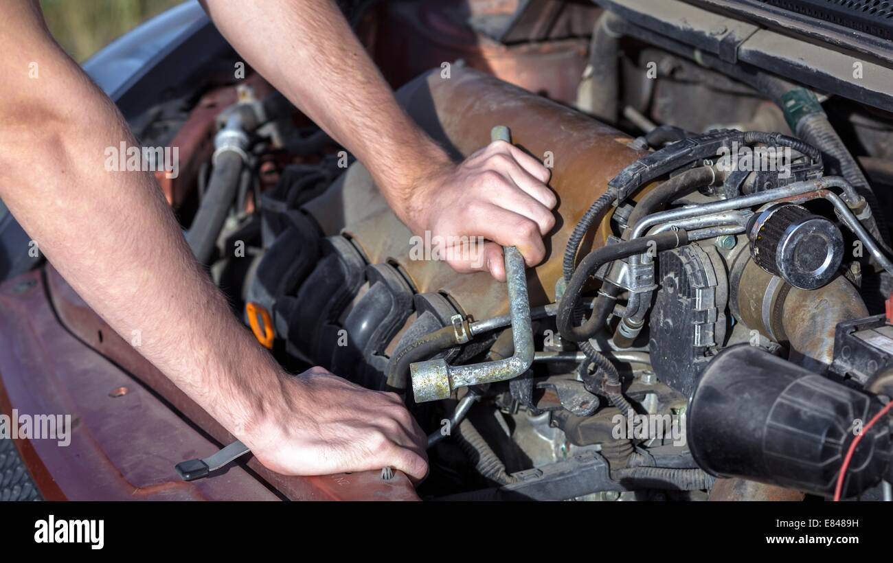 Man repairing motor block Stock Photo - Alamy