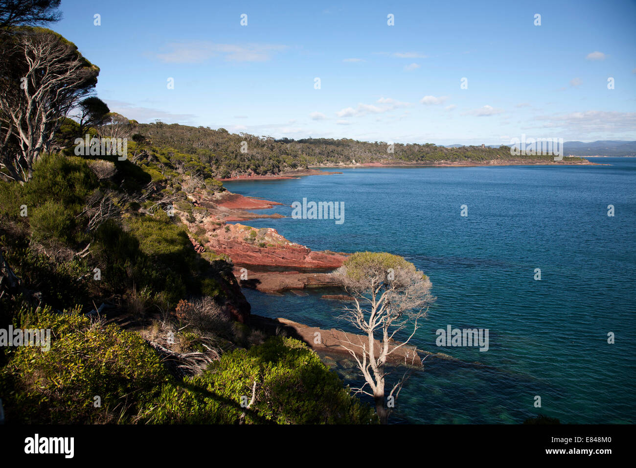 The distinctive red rocks and crystal clear waters of Ben Boyd National ...