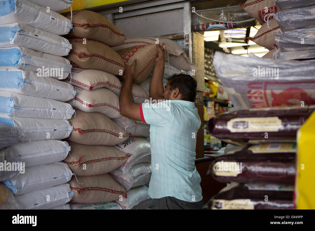 A man lifts a heavy bag of produce in the Deira Fruit & Vegetable ...