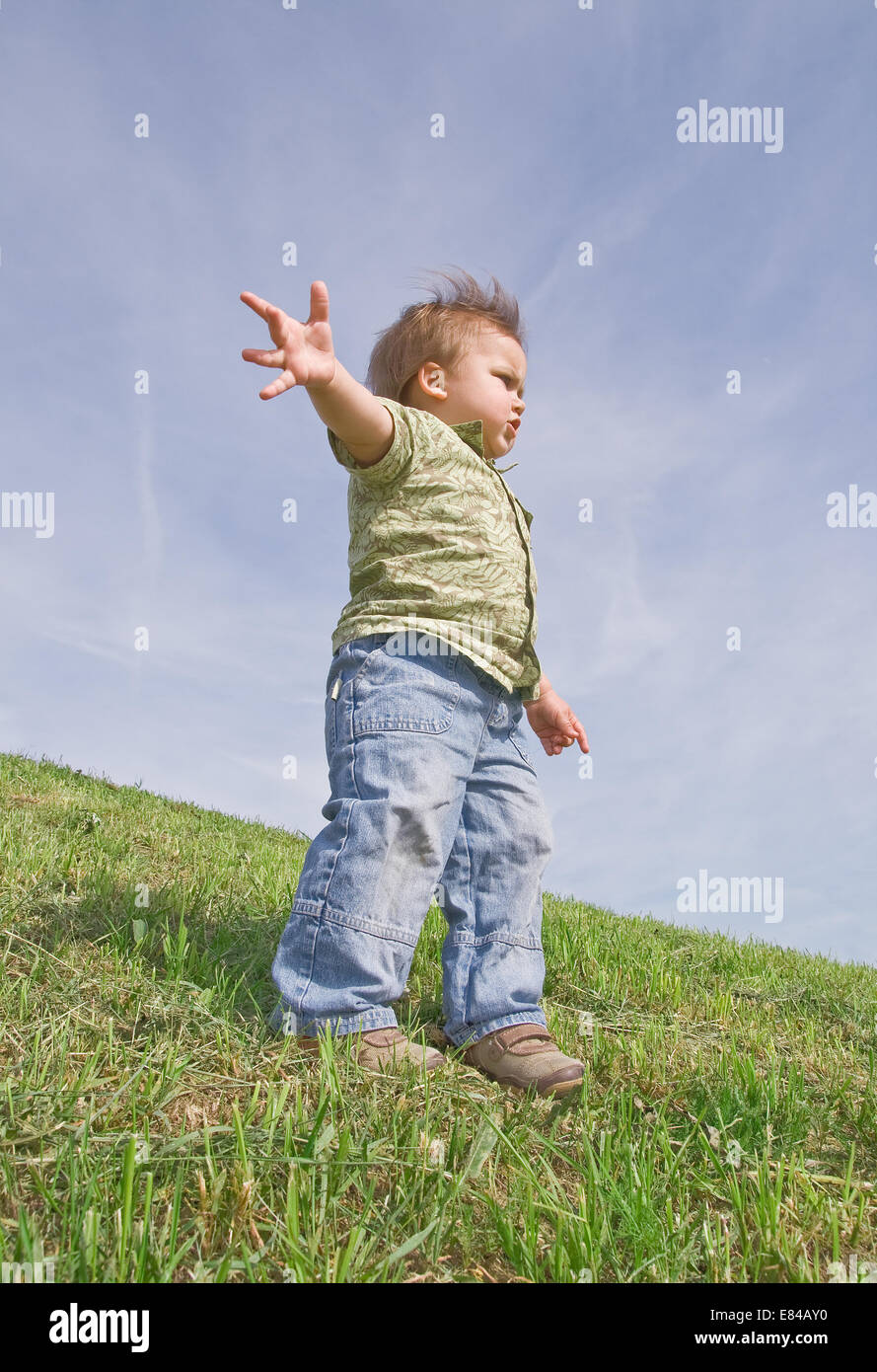 Toddler standing on a hill, view from below Stock Photo - Alamy