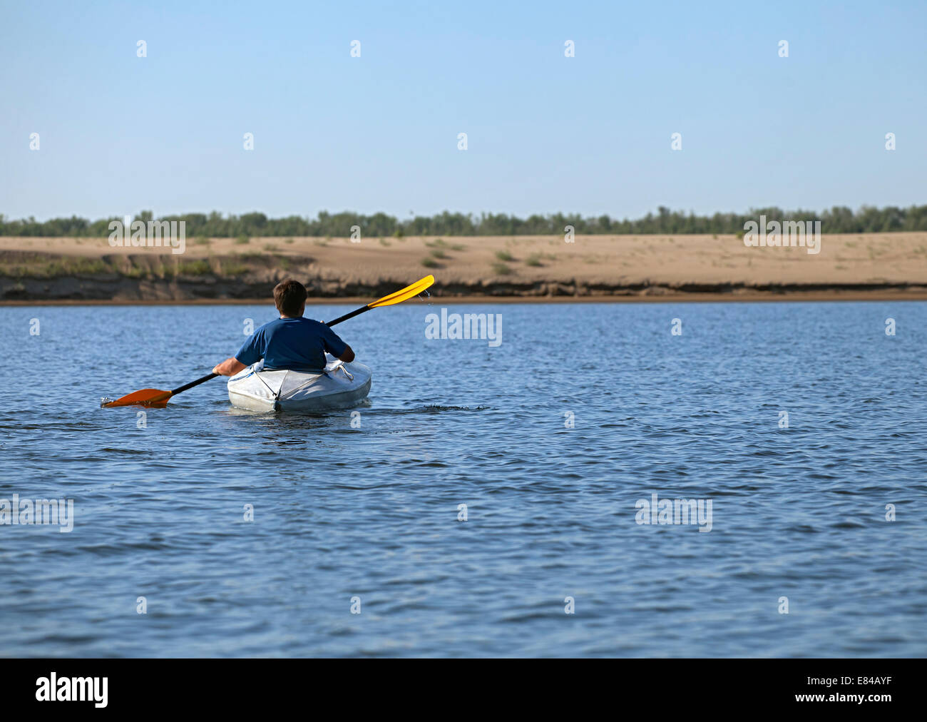 Back of a man rowing in the canoe Stock Photo - Alamy
