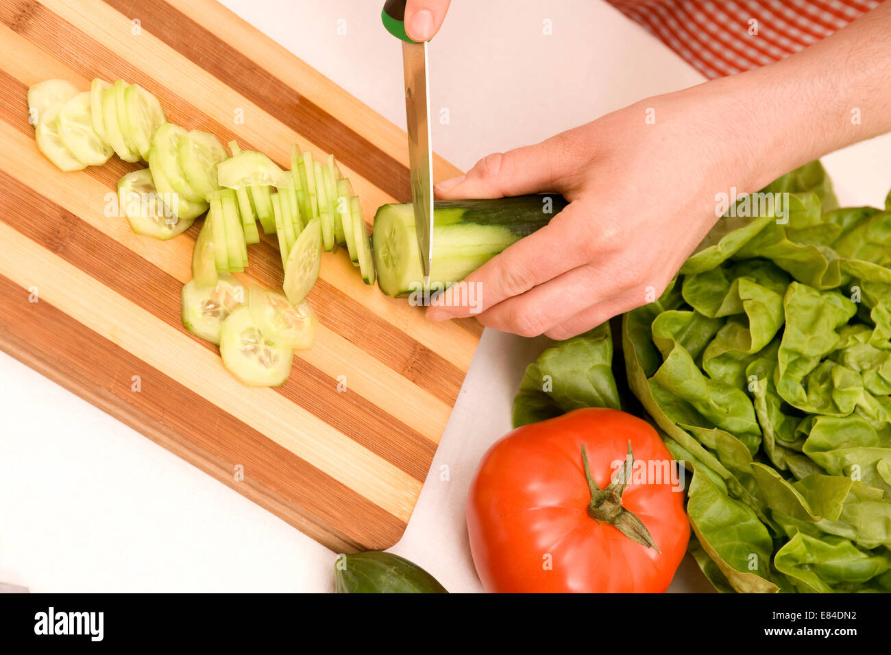 Woman slicing cucumbers hi-res stock photography and images - Alamy
