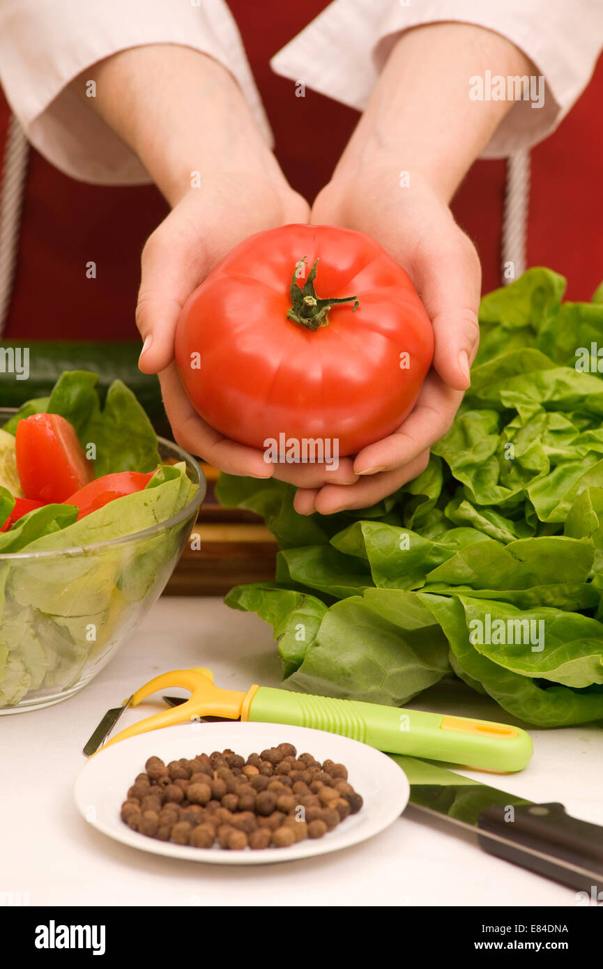 Human hands holding tomato Stock Photo - Alamy
