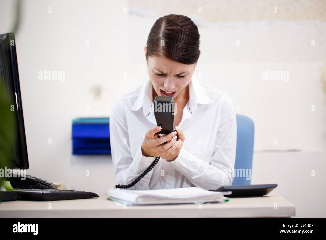 Angry woman shouting at phone Stock Photo - Alamy