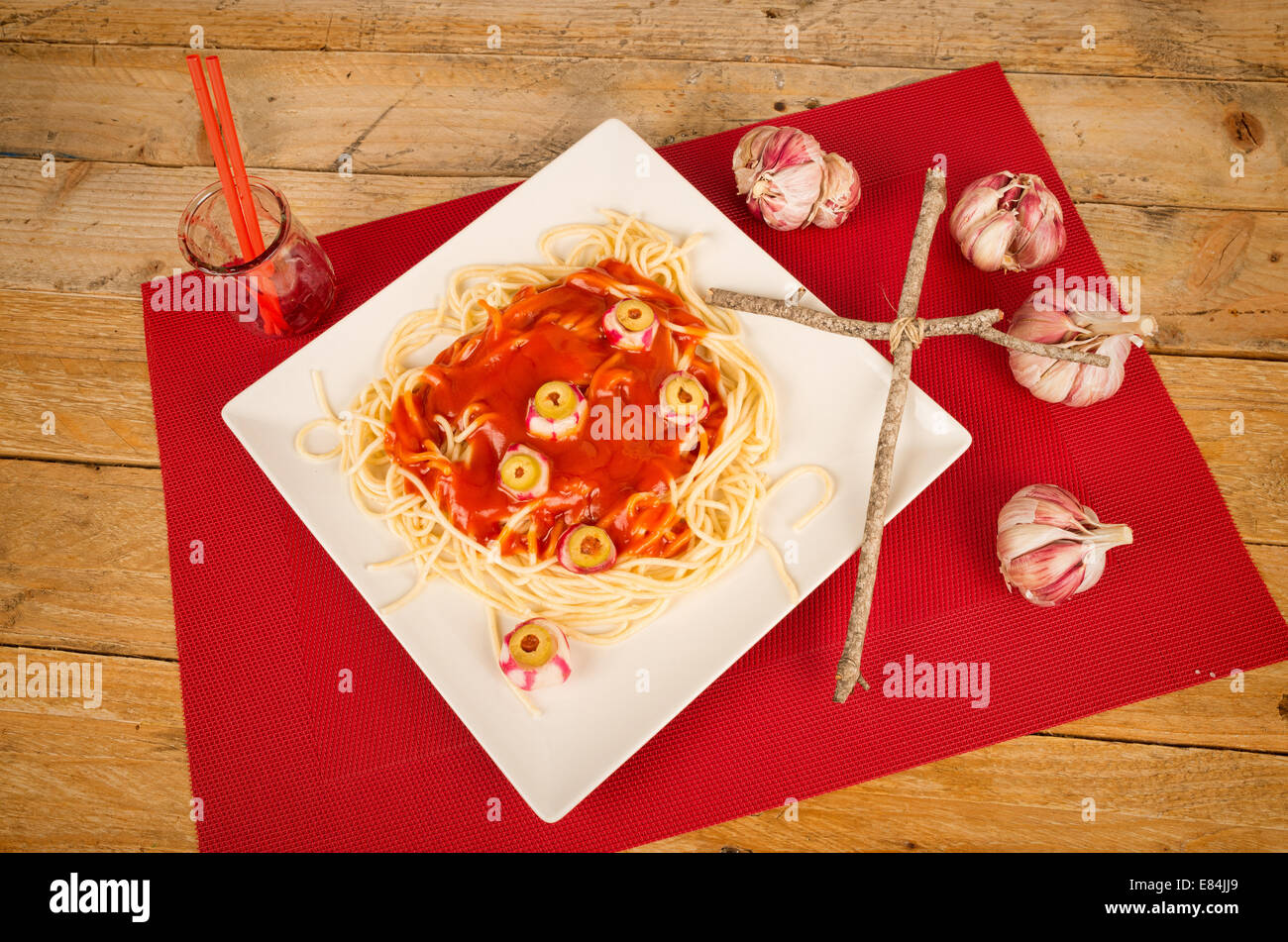 Portion of Halloween spaghetti with spooky eyes, a cross and garlic to ...