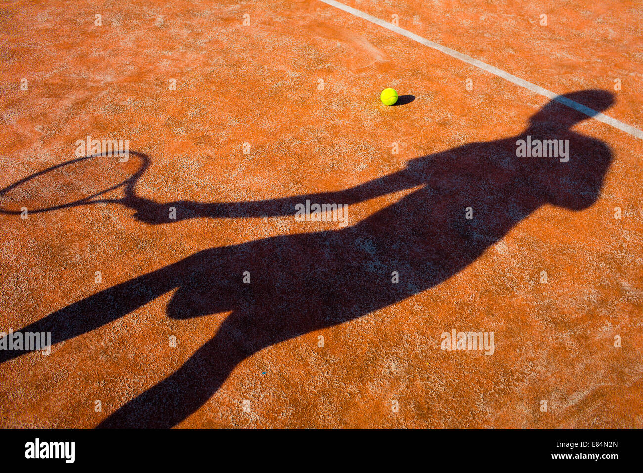 Shadow of a tennis player in action on a tennis court (conceptual image ...