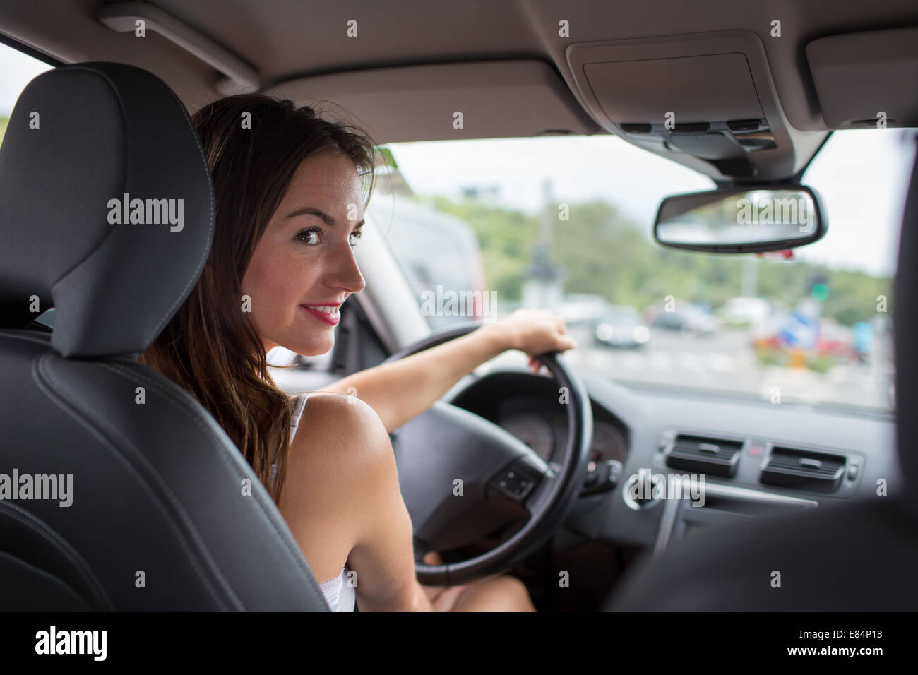 Young, attractive woman driving a car, going home from work Stock Photo ...