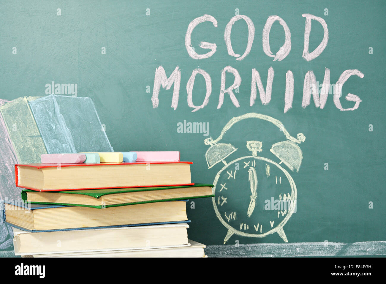 Good morning! Chalk drawing of books, alarm clock and writing wish ...
