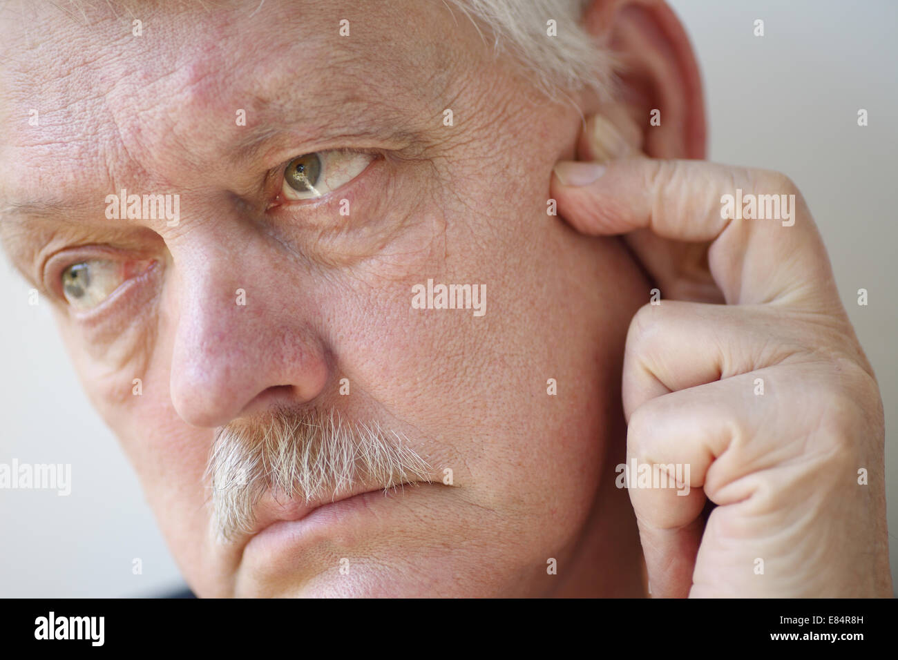 closeup of senior man with fingers next to his ear Stock Photo - Alamy