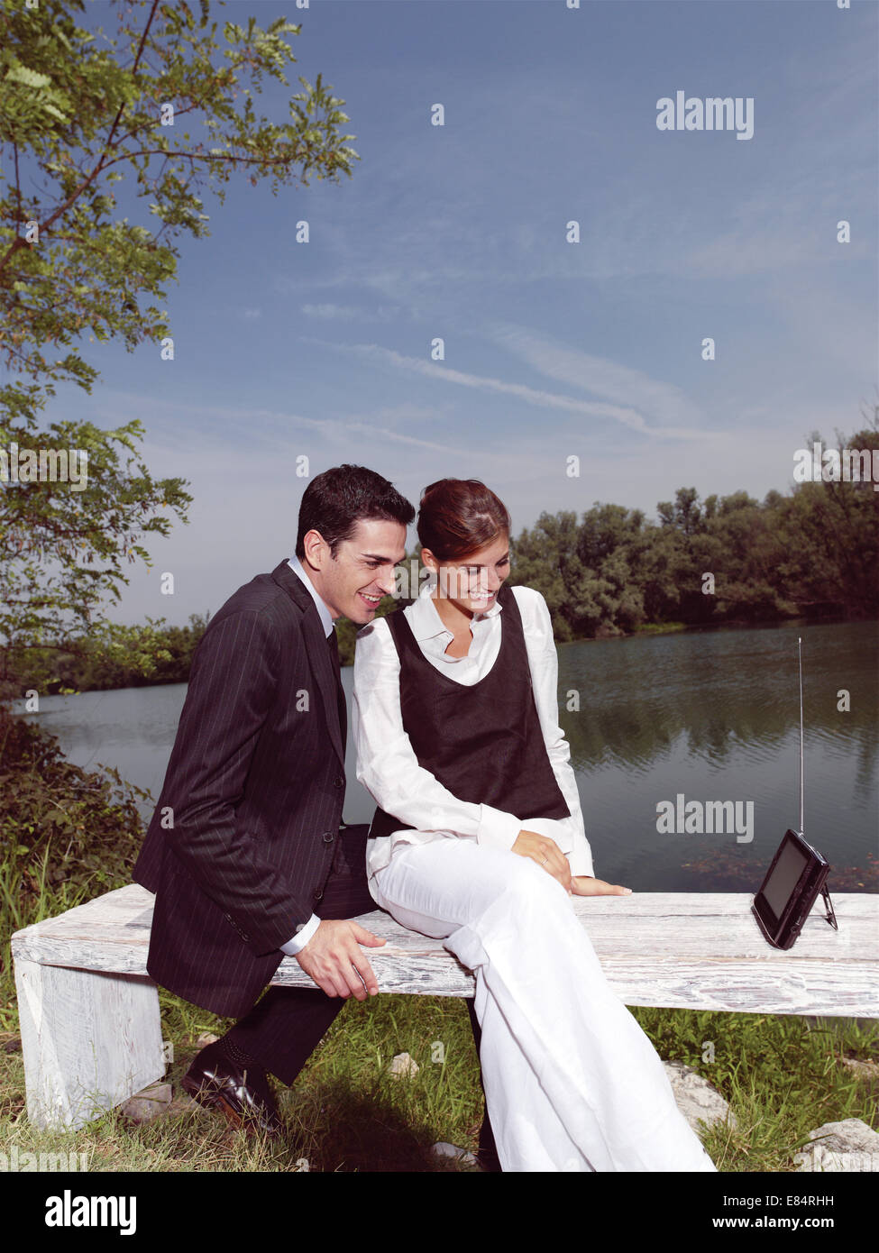Beautiful young people using PDA outdoors Stock Photo - Alamy