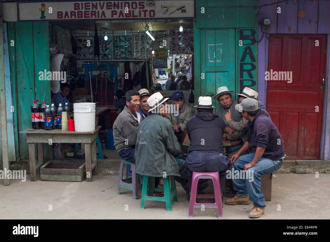 Indigenous men sitting and talking at a table at barber shop, Travel to ...