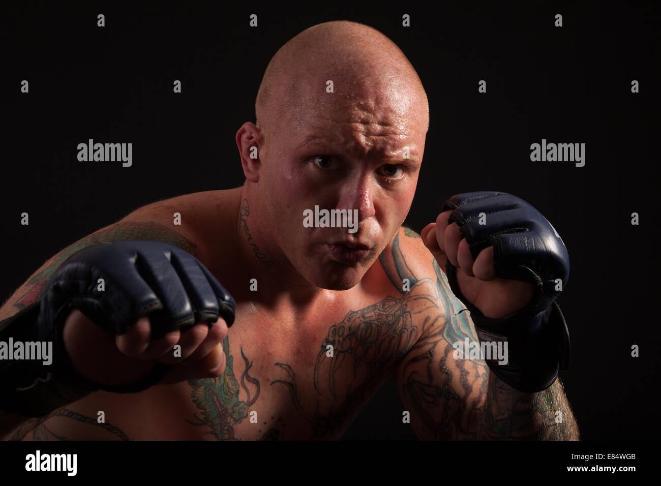 Cage Fighter during work out and warm up. Looking menacingly into ...
