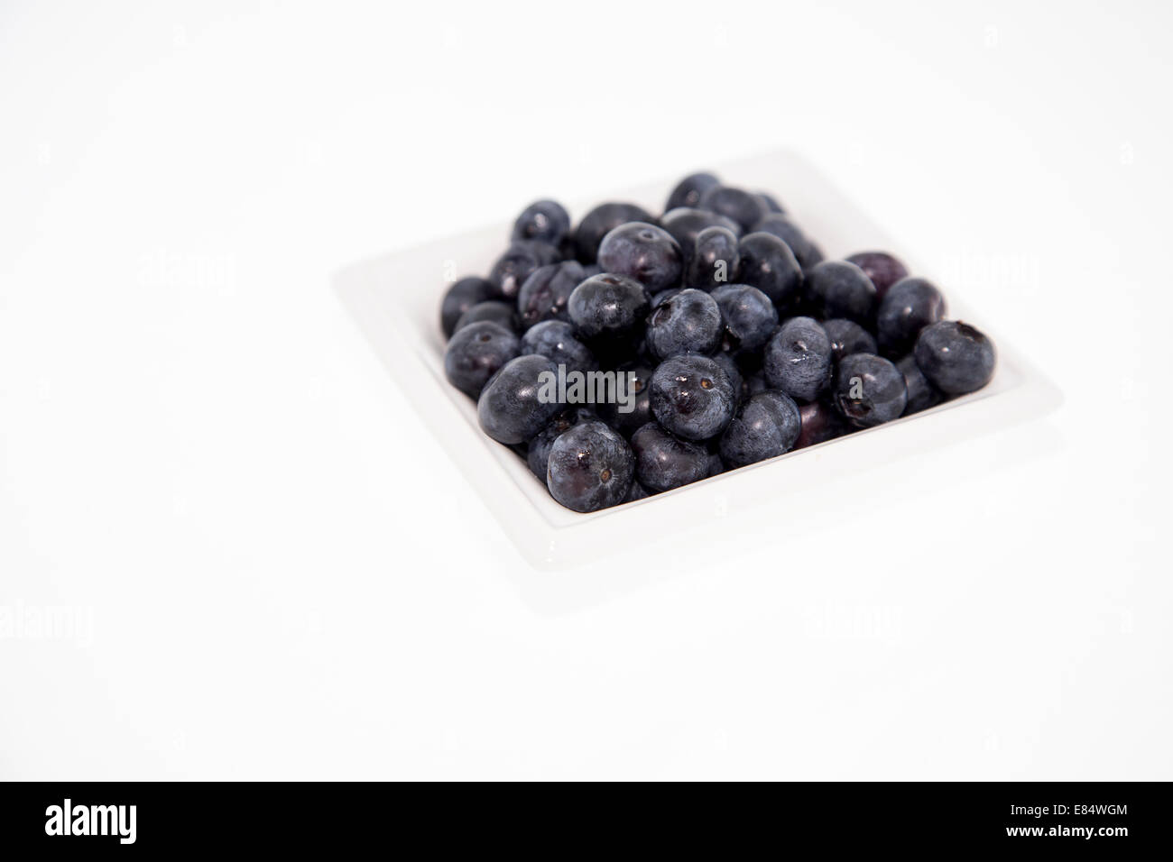 Organic blueberry in a bowl isolated on white background Stock Photo ...