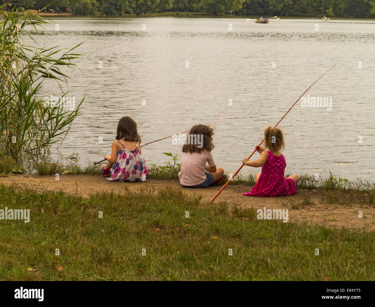 Young girls learning to fish at the lake at Prospect Park, Brooklyn, NY ...