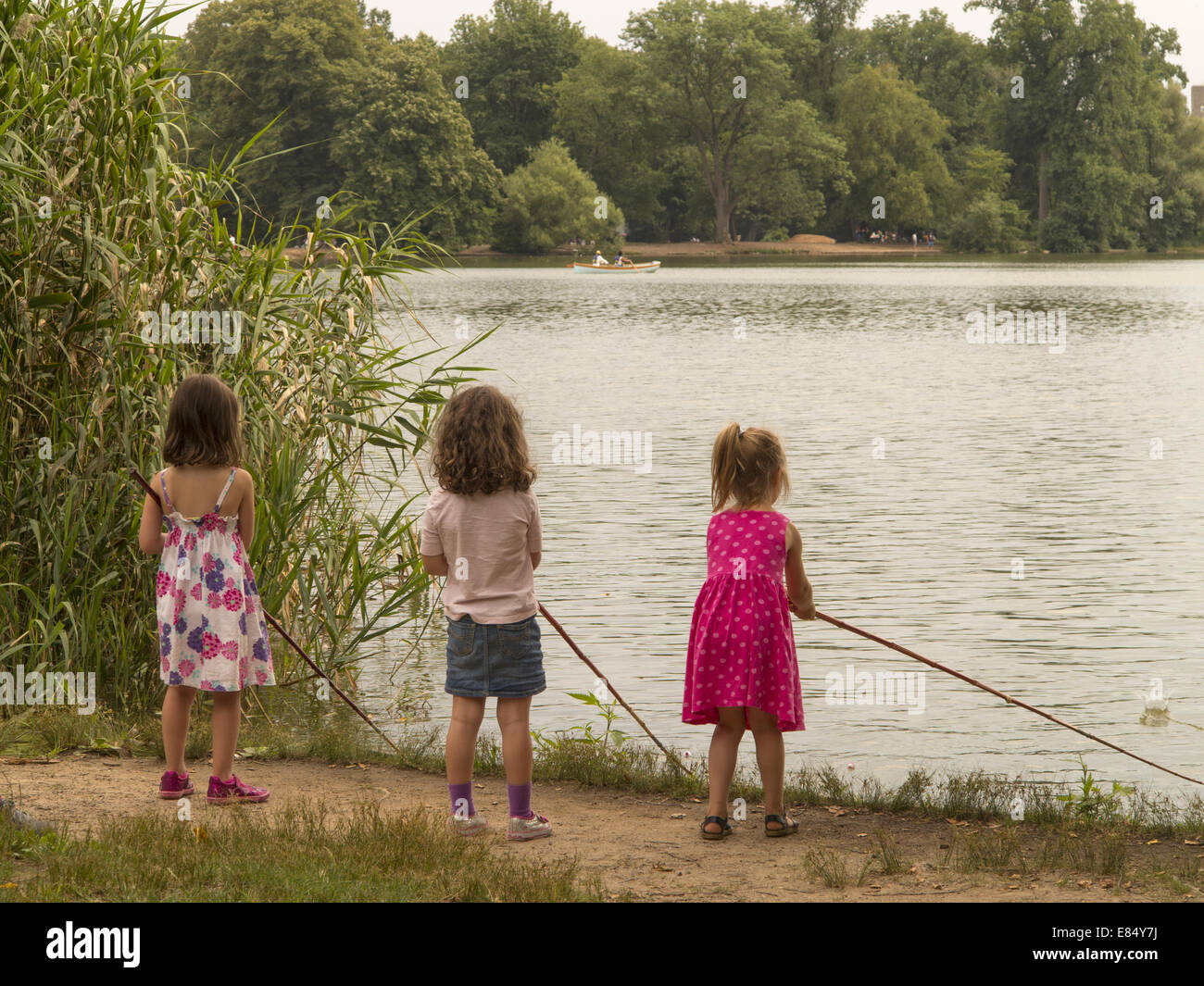 Young girls learning to fish at the lake at Prospect Park, Brooklyn, NY ...