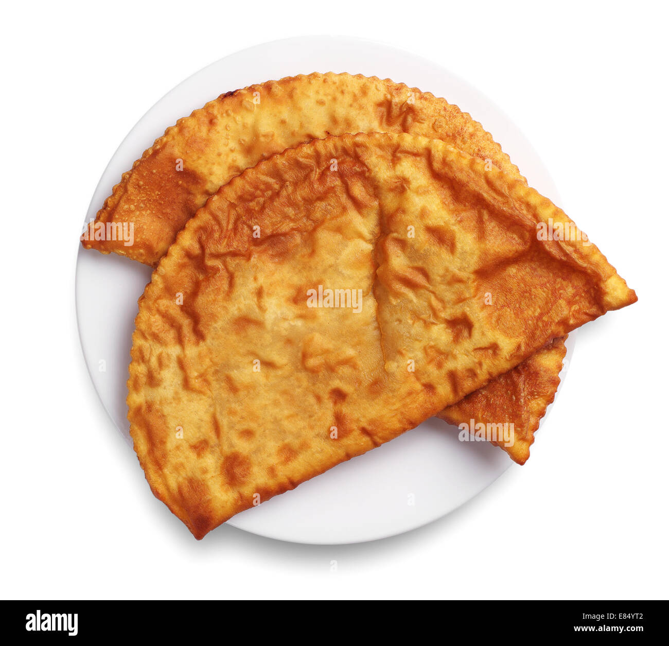 Two tasty pasties in a plate on white background Stock Photo - Alamy