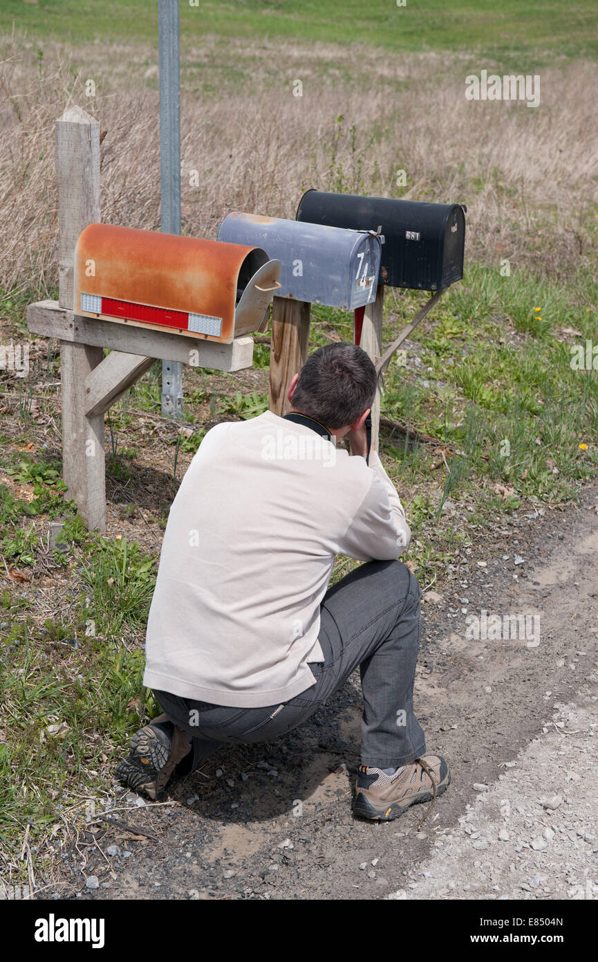 Photographer taking a picture of rural mailboxes Stock Photo - Alamy