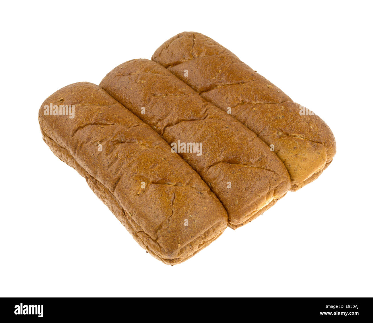 A group of freshly baked whole wheat sub rolls on a white background ...