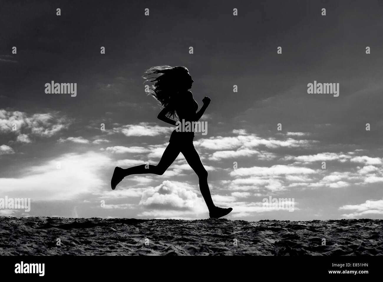 Silhouette of a girl runner effect films Stock Photo - Alamy