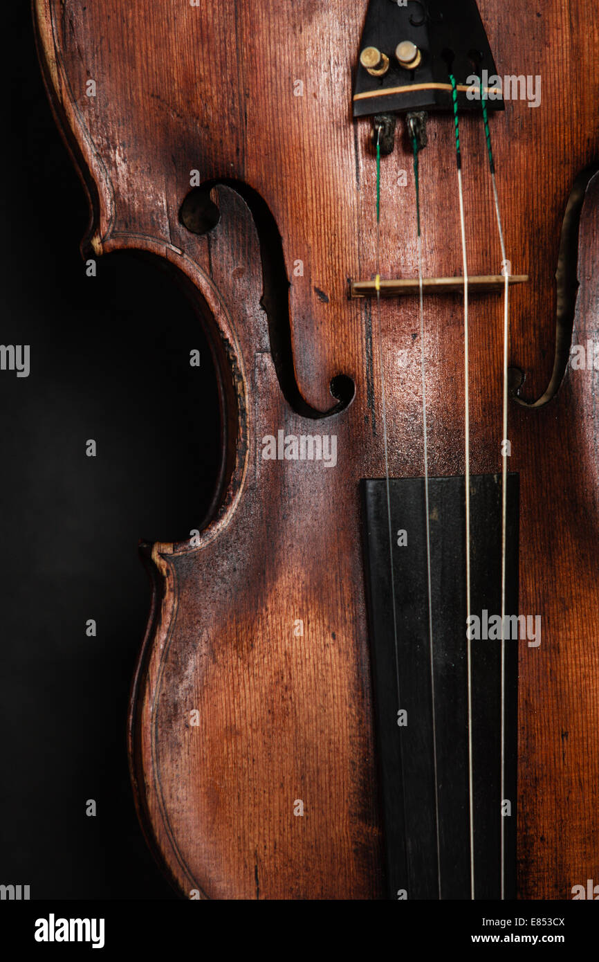 Art. Closeup of old wooden violin stringed instrument on dark gray ...
