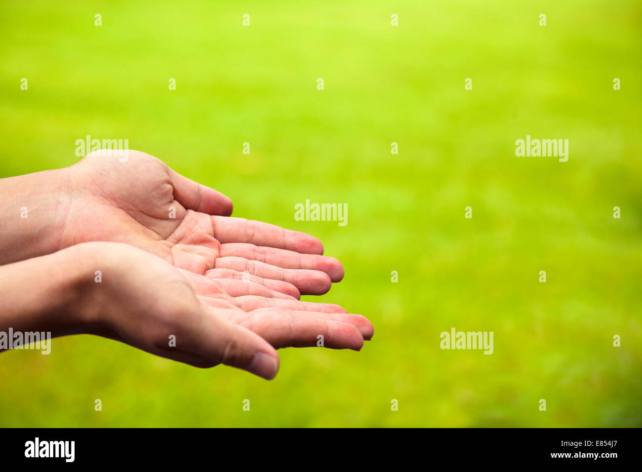 closeup of hands with green background in outdoor Stock Photo - Alamy