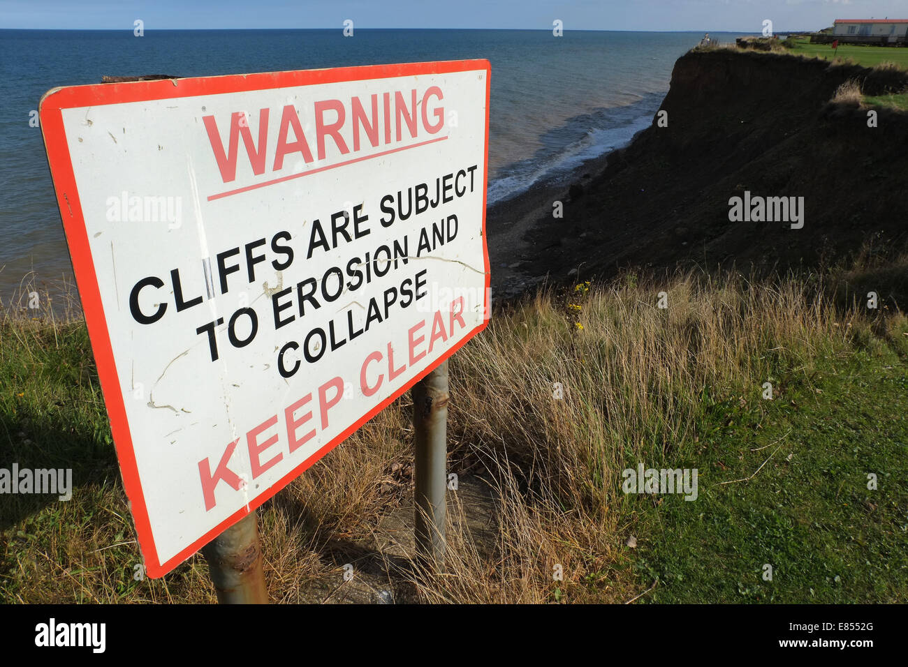 Danger sign for cliff face erosion Stock Photo - Alamy