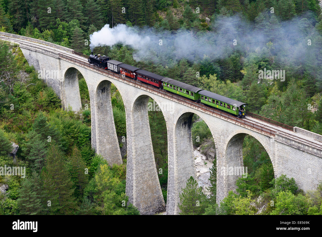 HISTORIC & TOURISTIC STEAM TRAIN ON A VIADUCT (aerial view). Train ...