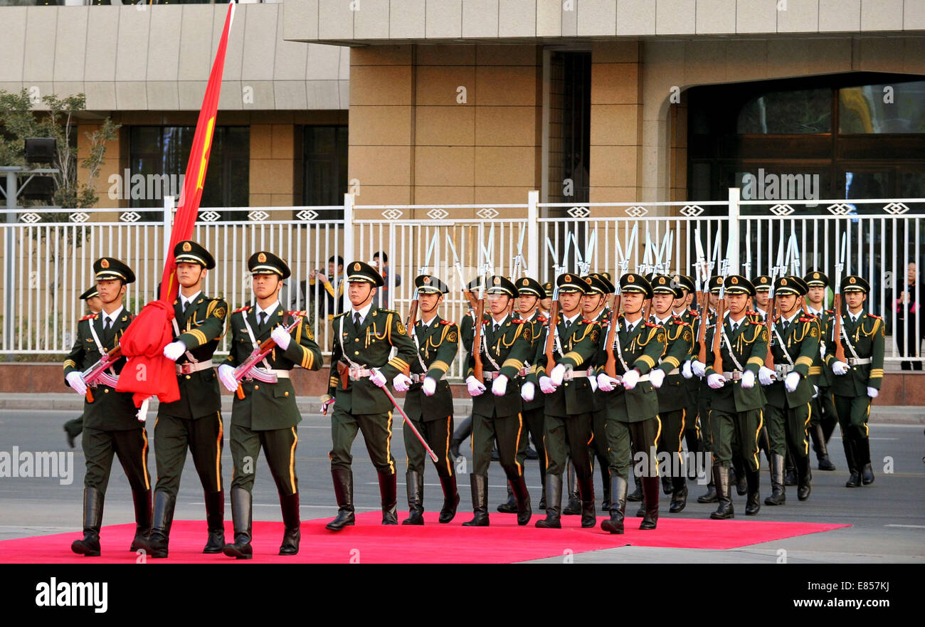 Urumqi. 1st Oct, 2014. A flag-raising ceremony marking the 65th ...