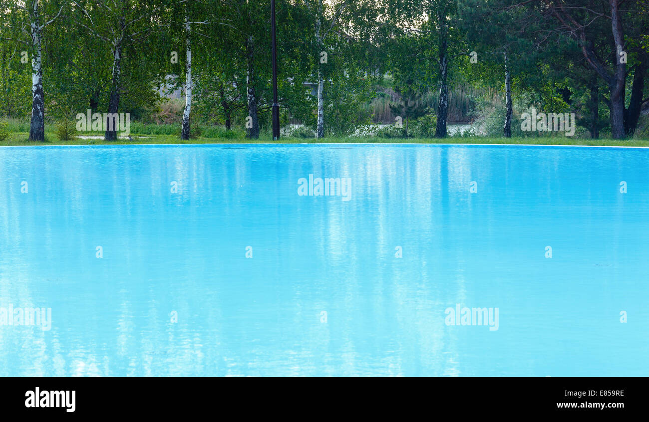 Outdoor swimming pool view with tree reflection on water surface Stock ...