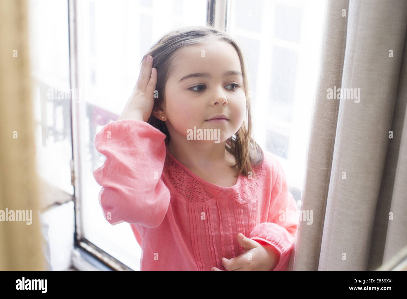 Little girl in front of window Stock Photo - Alamy