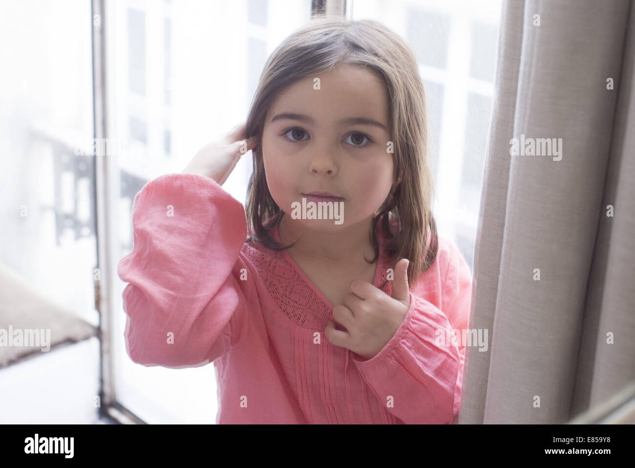 Little girl in front of window, portrait Stock Photo - Alamy