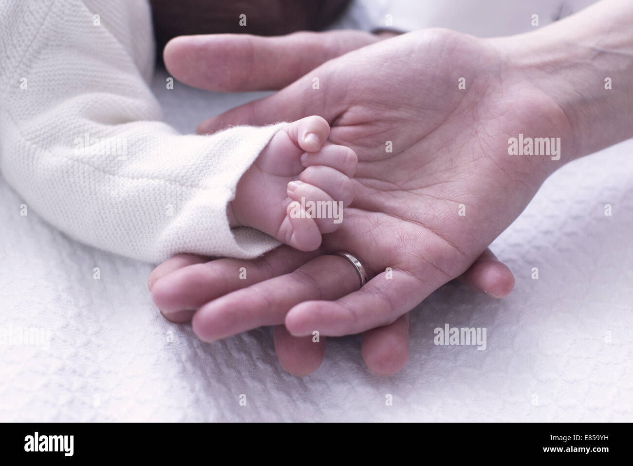 Baby boys hand resting on mothers hand hi-res stock photography and ...