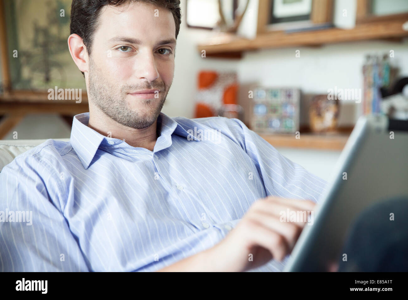 Man using digital tablet at home Stock Photo - Alamy