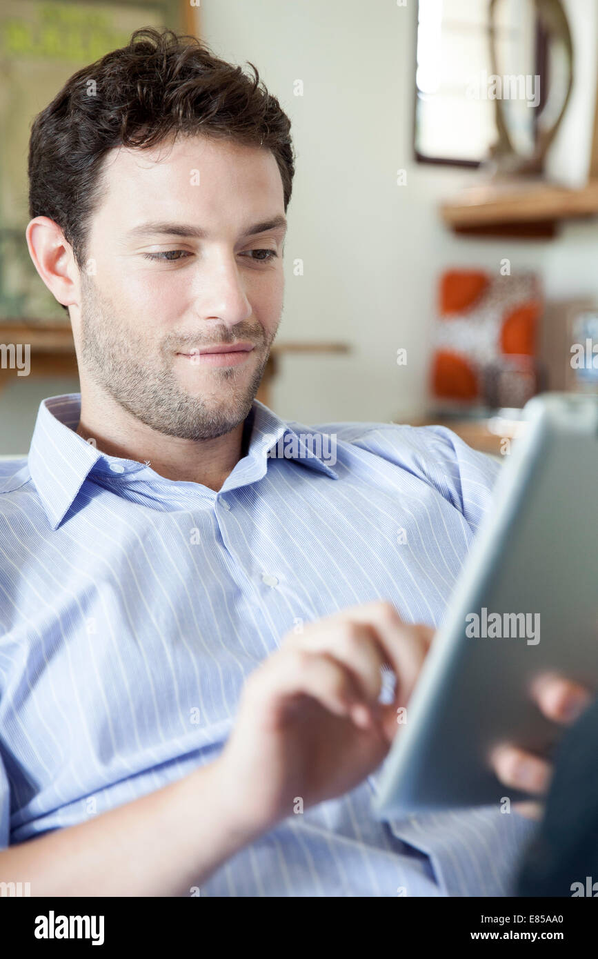 Man using digital tablet at home Stock Photo - Alamy