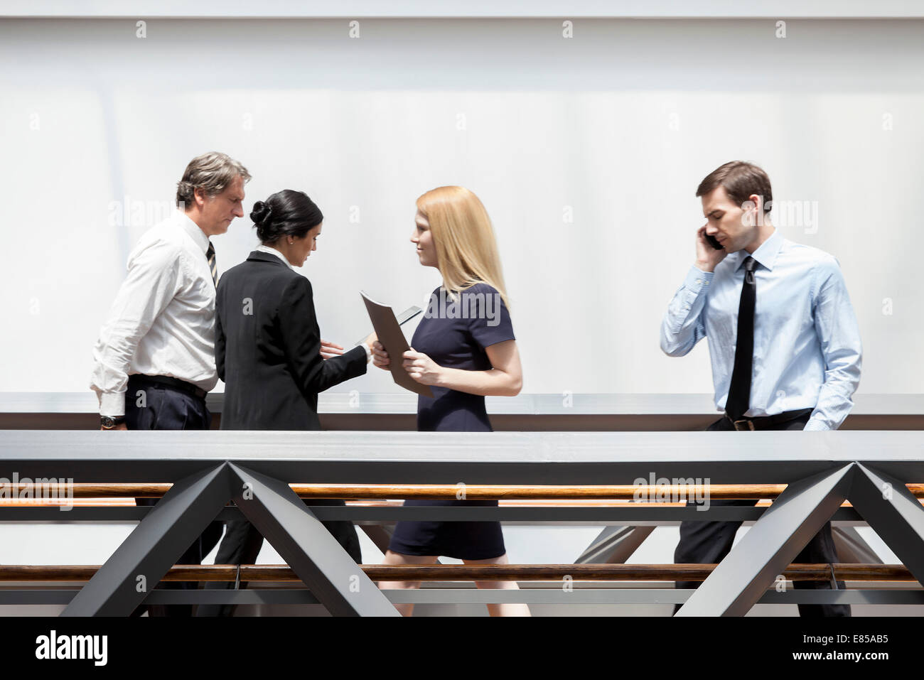 Executives walking in corridor Stock Photo - Alamy
