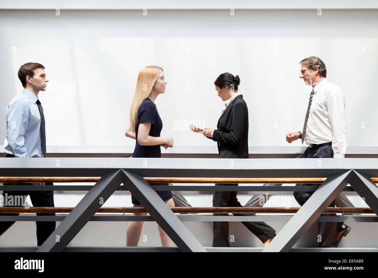 Executives walking in corridor Stock Photo - Alamy