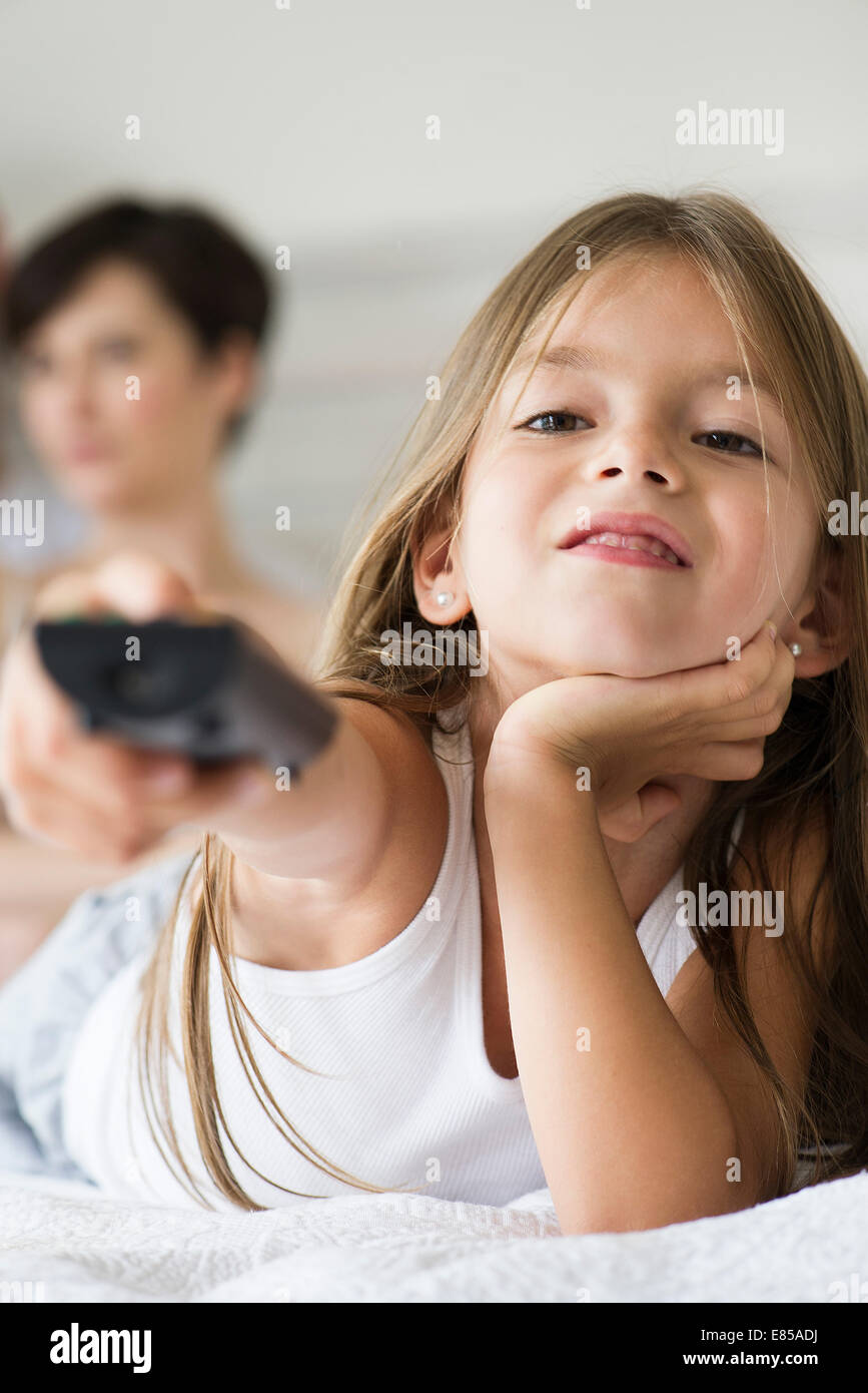 Little girl holding remote control Stock Photo - Alamy