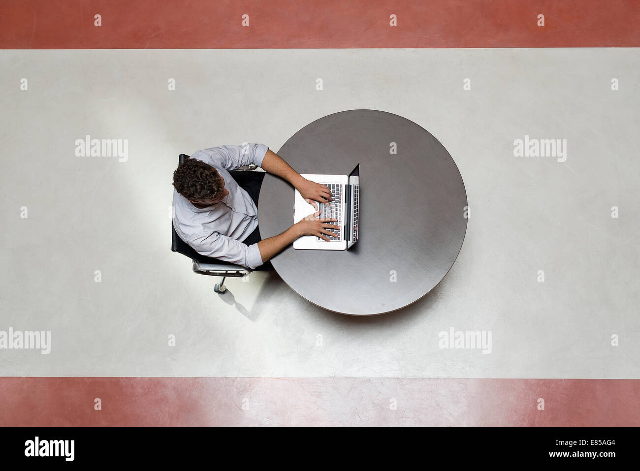 College student using laptop computer alone in breakroom Stock Photo ...