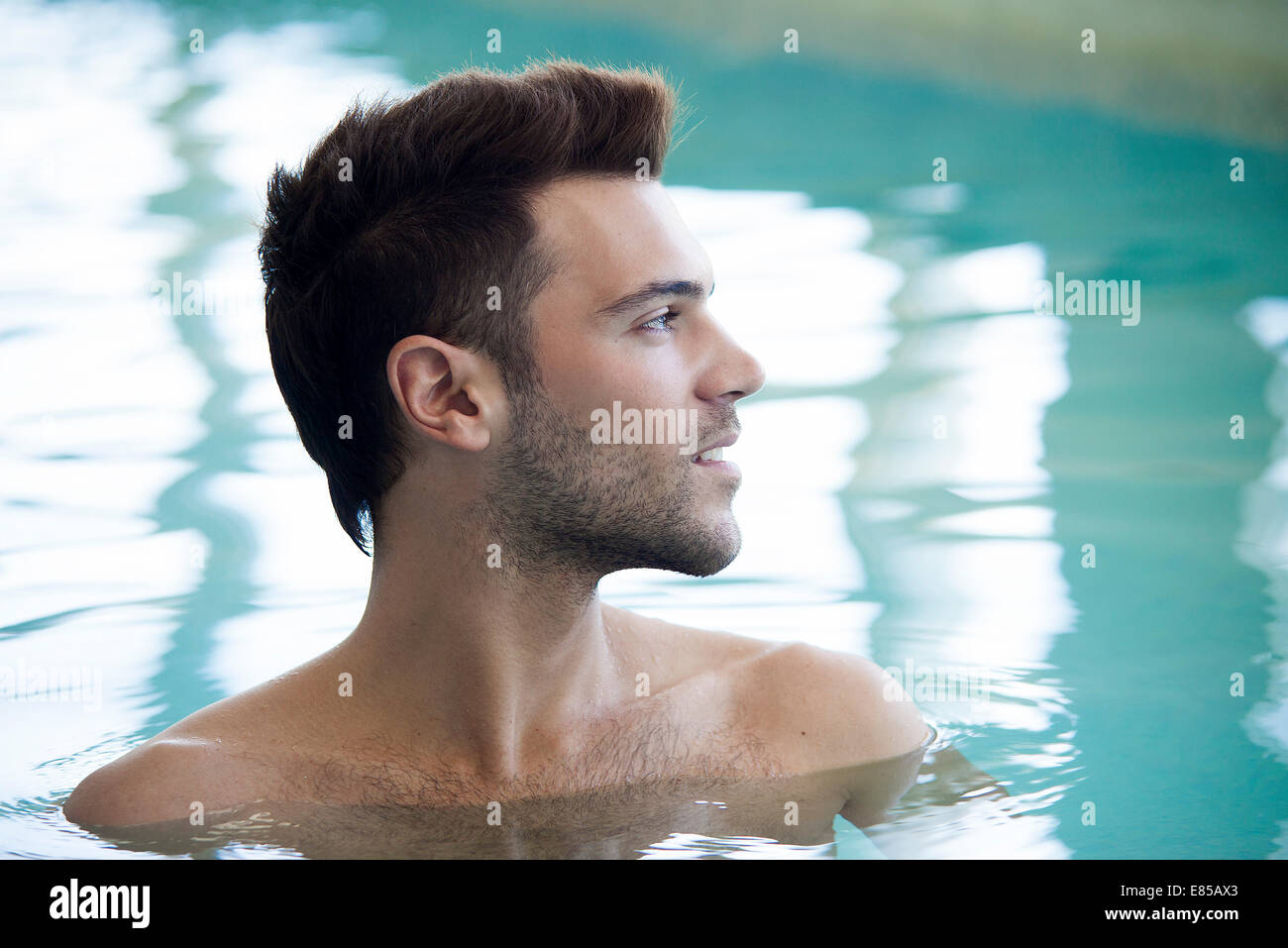 Young man relaxing in pool Stock Photo - Alamy