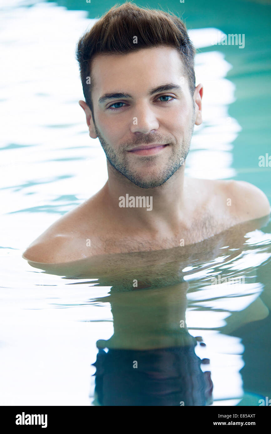 Young man in swimming pool Stock Photo - Alamy