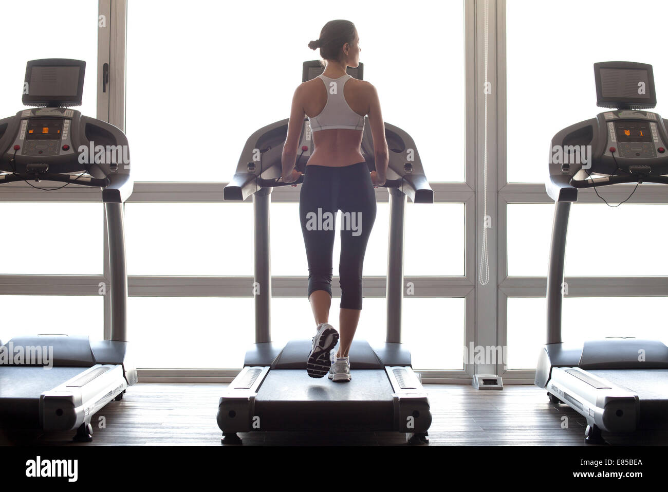 Woman jogging on treadmill at gym Stock Photo - Alamy