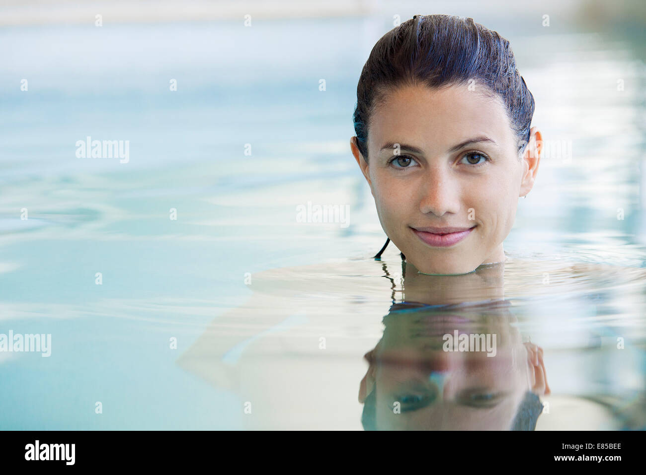 Woman relaxing in swimming pool, portrait Stock Photo - Alamy