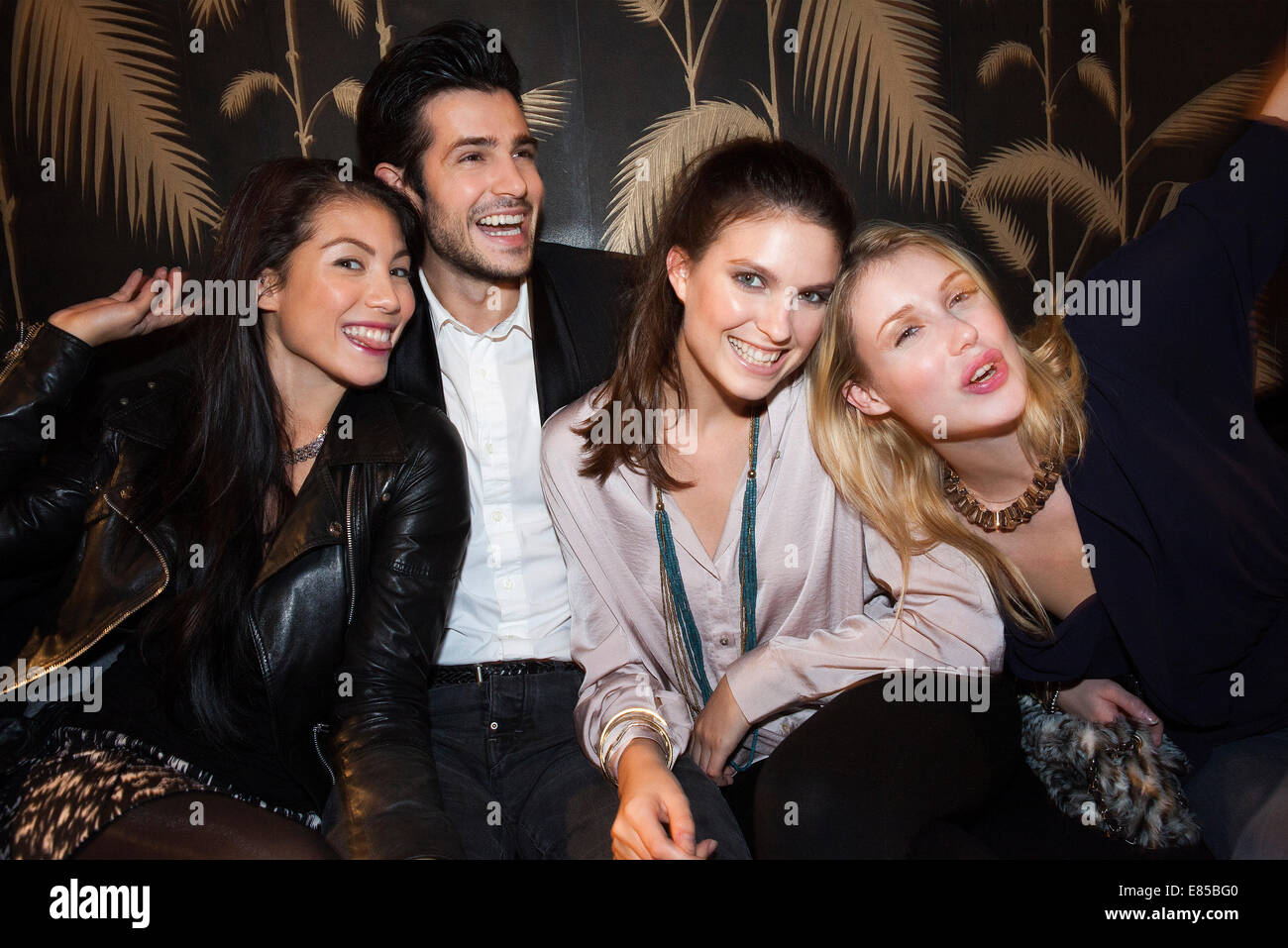 Friends hanging out at night club Stock Photo - Alamy