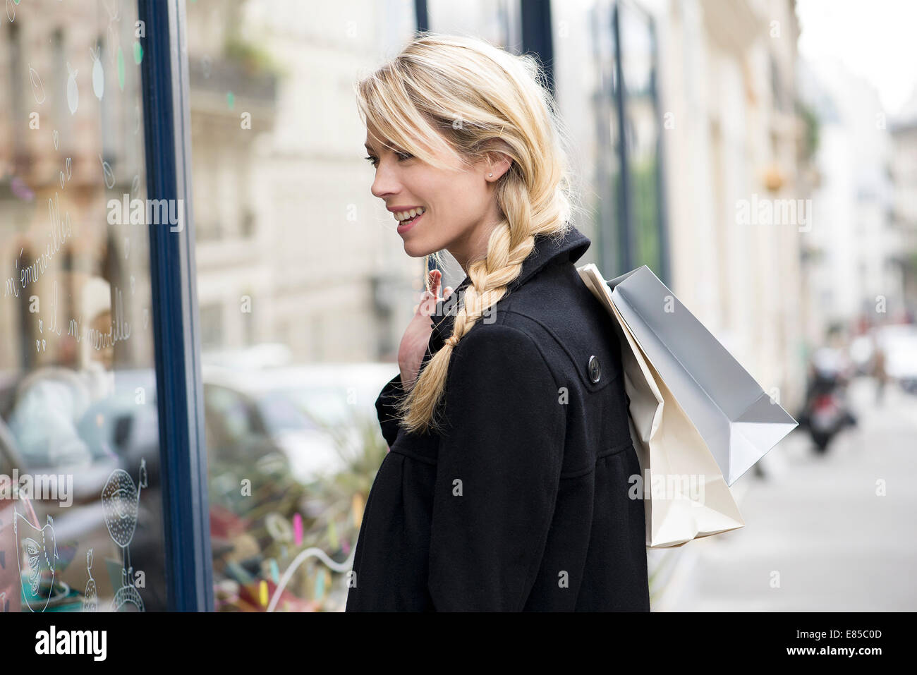 Woman window shopping Stock Photo - Alamy