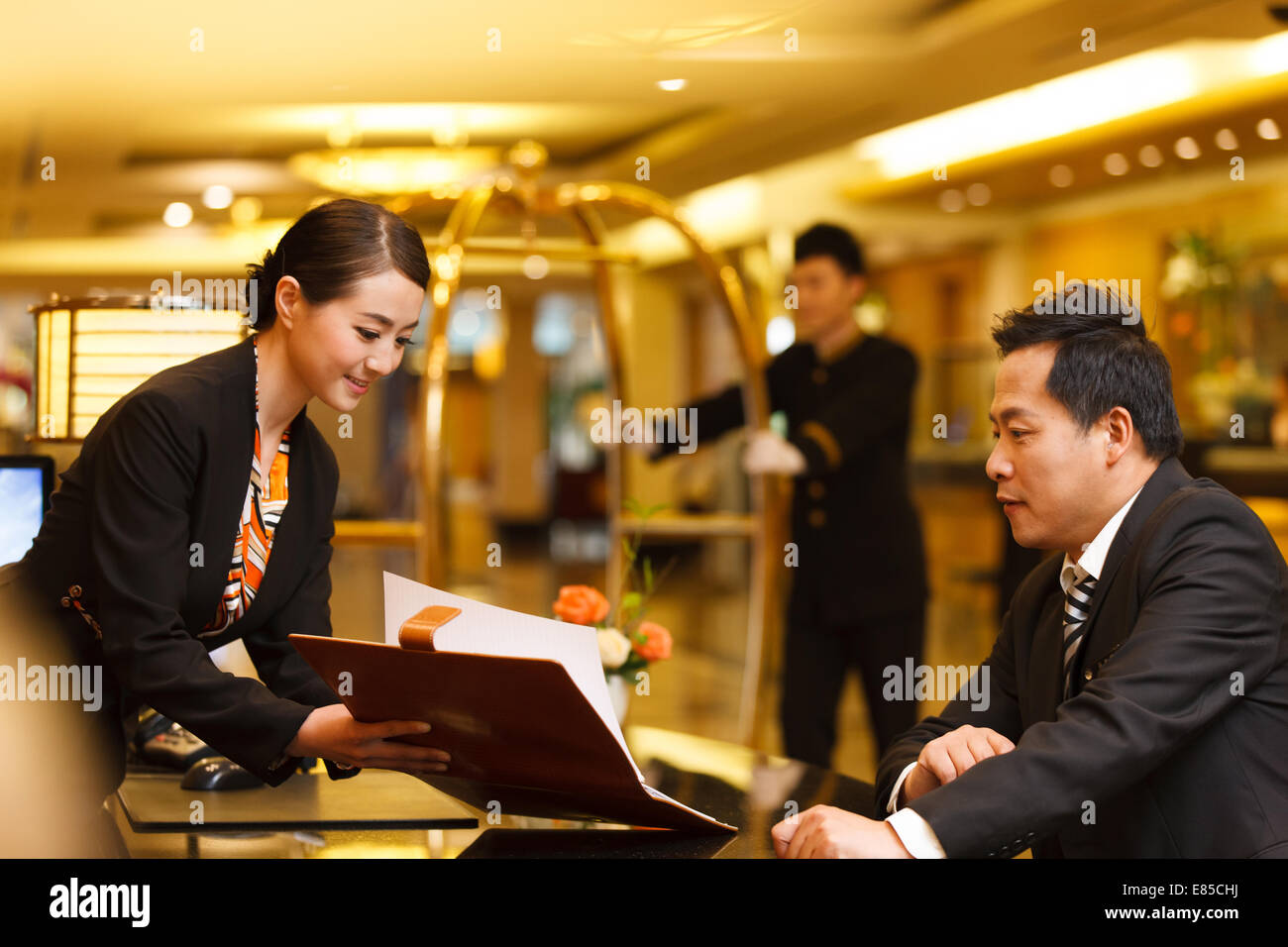 Businessman at hotel reception Stock Photo - Alamy
