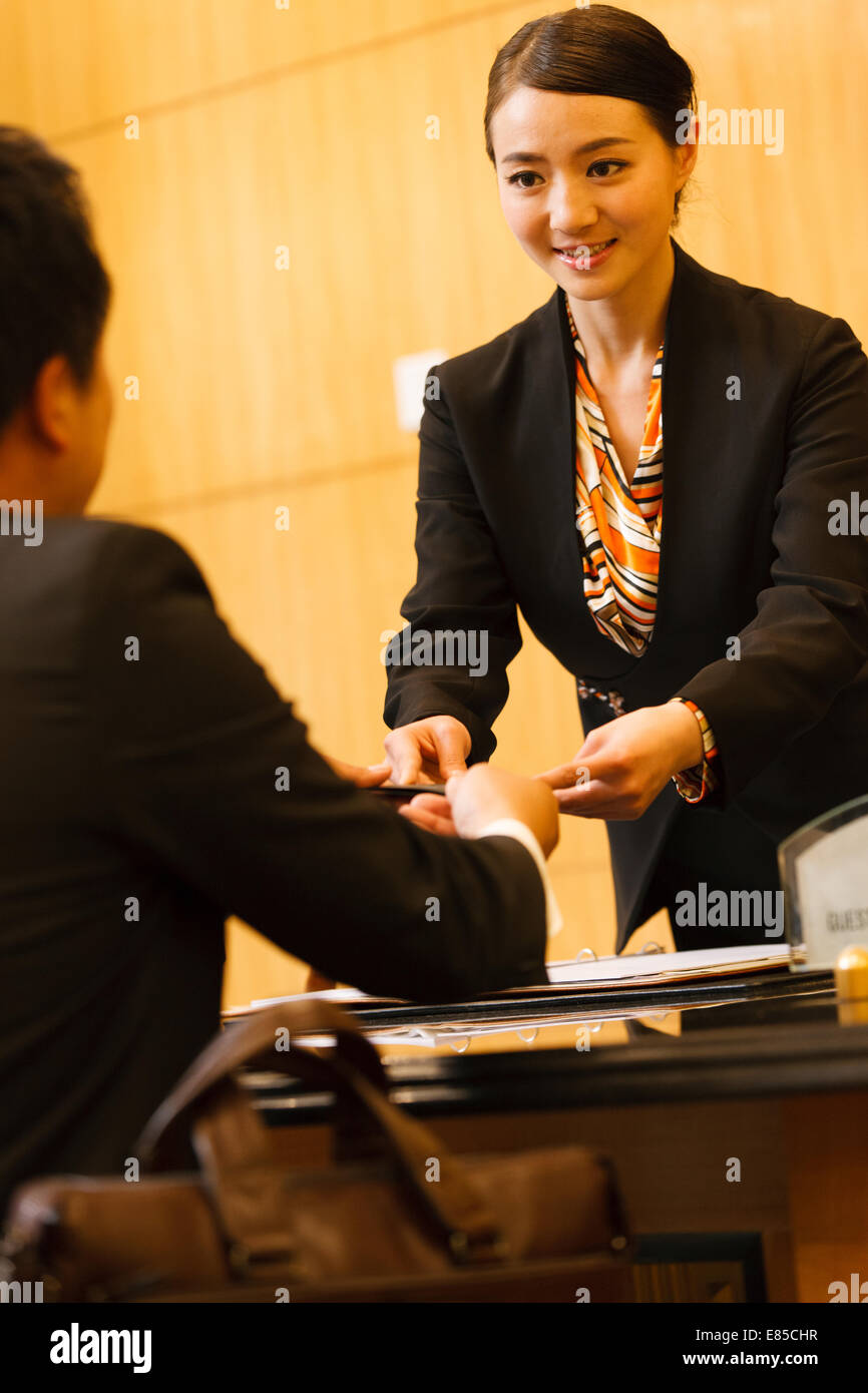 Businessman at hotel reception Stock Photo - Alamy