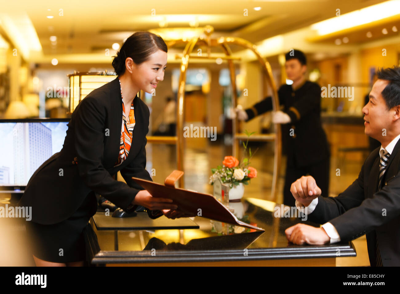 Businessman at hotel reception Stock Photo - Alamy