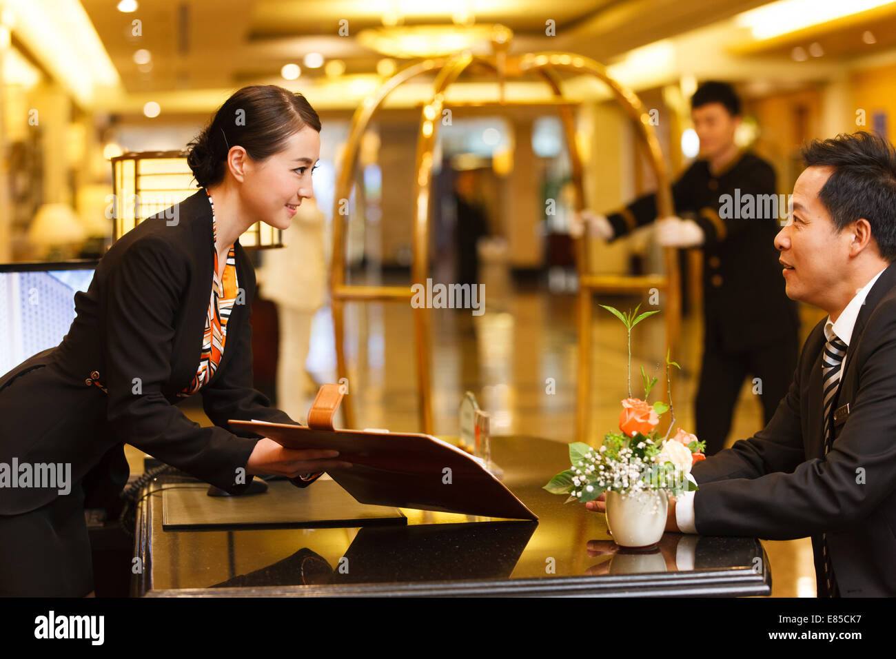 Businessman at hotel reception Stock Photo - Alamy