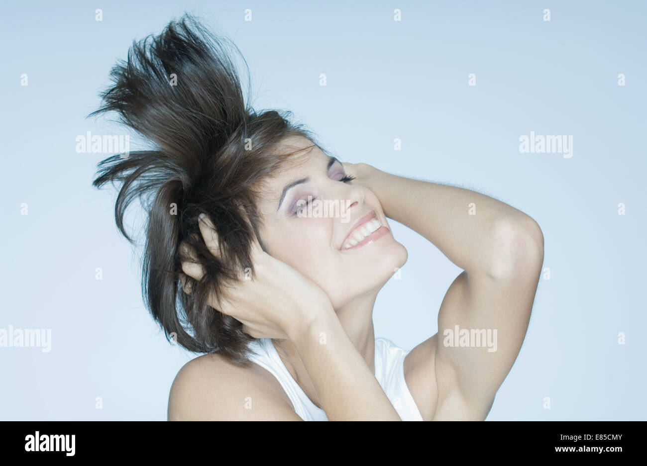 Woman tossing hair and smiling, portrait Stock Photo - Alamy